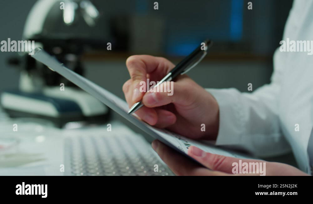 Hands of Forensic Scientist Taking Notes on Paper in Crime Lab Stock ...