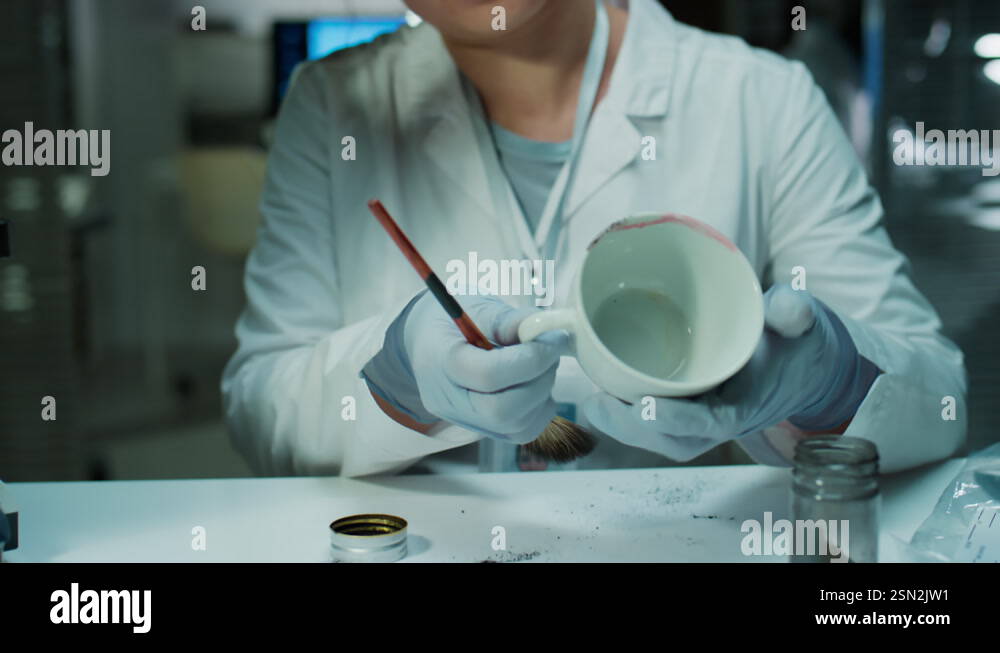 Female Forensic Technician Applying Fingerprint Powder to Mug with ...