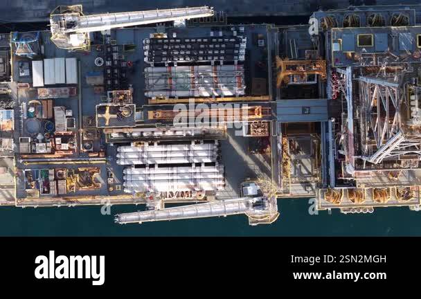 High above an expansive industrial facility featuring extensive piping ...