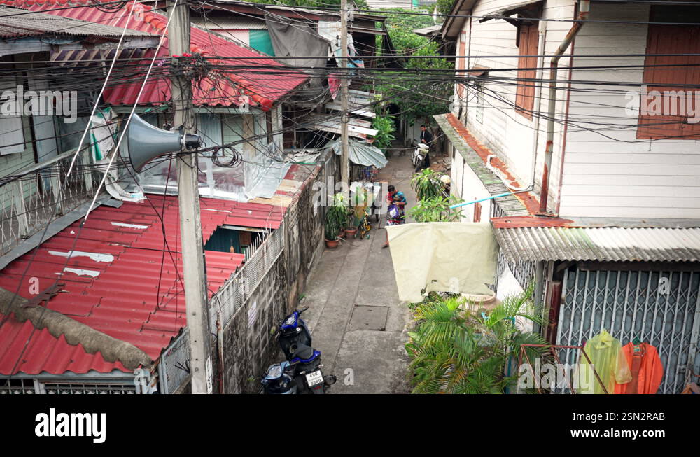 Bangkok, Thailand - 06/20/2024: In Bangkok’s alleys, shadows fall, homes Stock Video Footage - Alamy