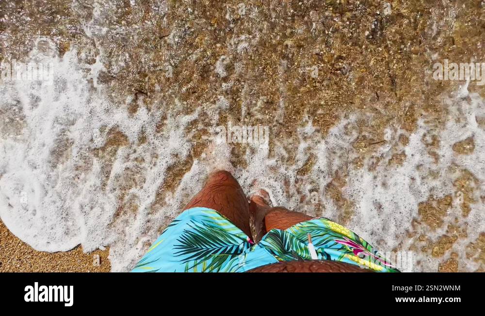 Handsome man walking slowly on the beach Stock Video Footage - Alamy