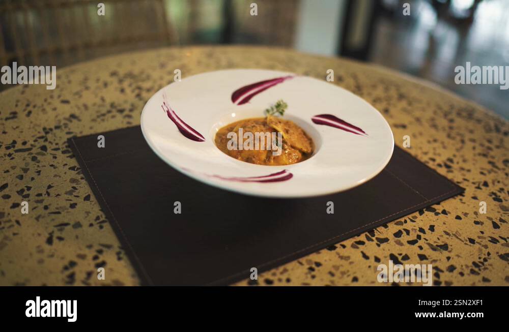 A slow panning shot around a freshly made orange chicken curry served ...