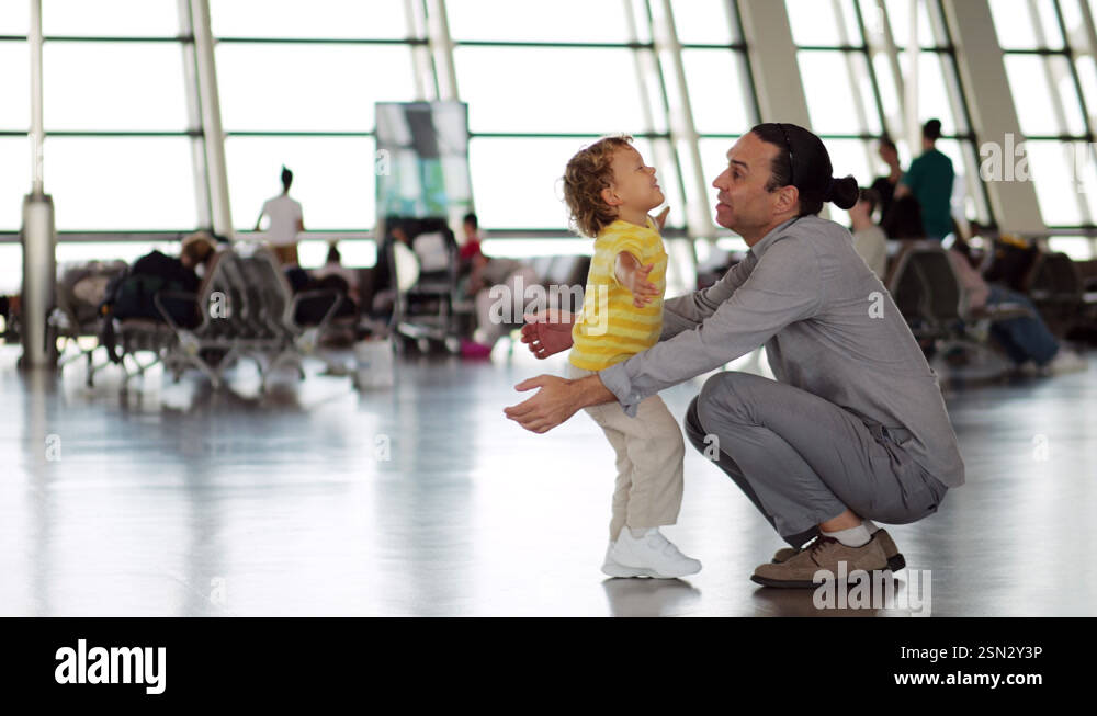Young son come with open arms and hugs father, slow motion shot in ...