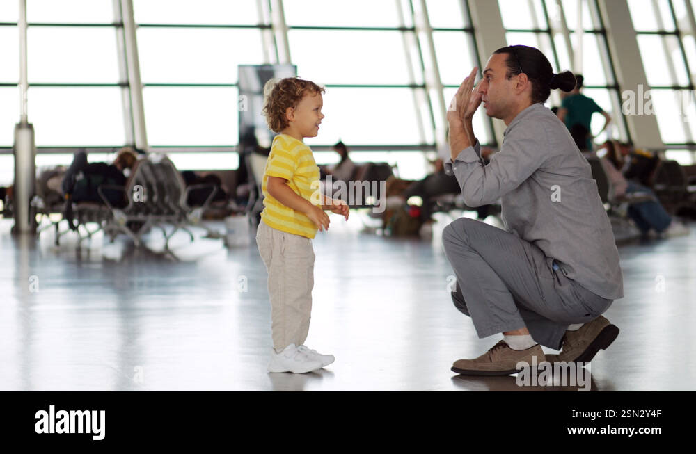 Joyful little boy and father do double high five, then a low five, then ...
