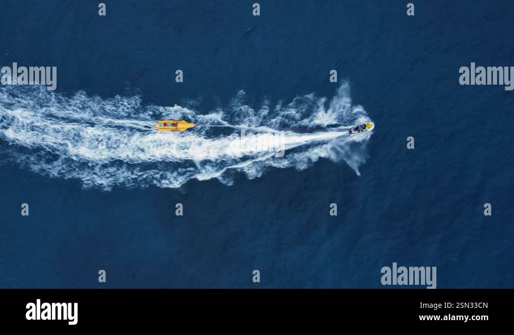 Fun Water Tubing Ride on Banana Boat Sea Sled Towed to Speeding Jet Ski ...