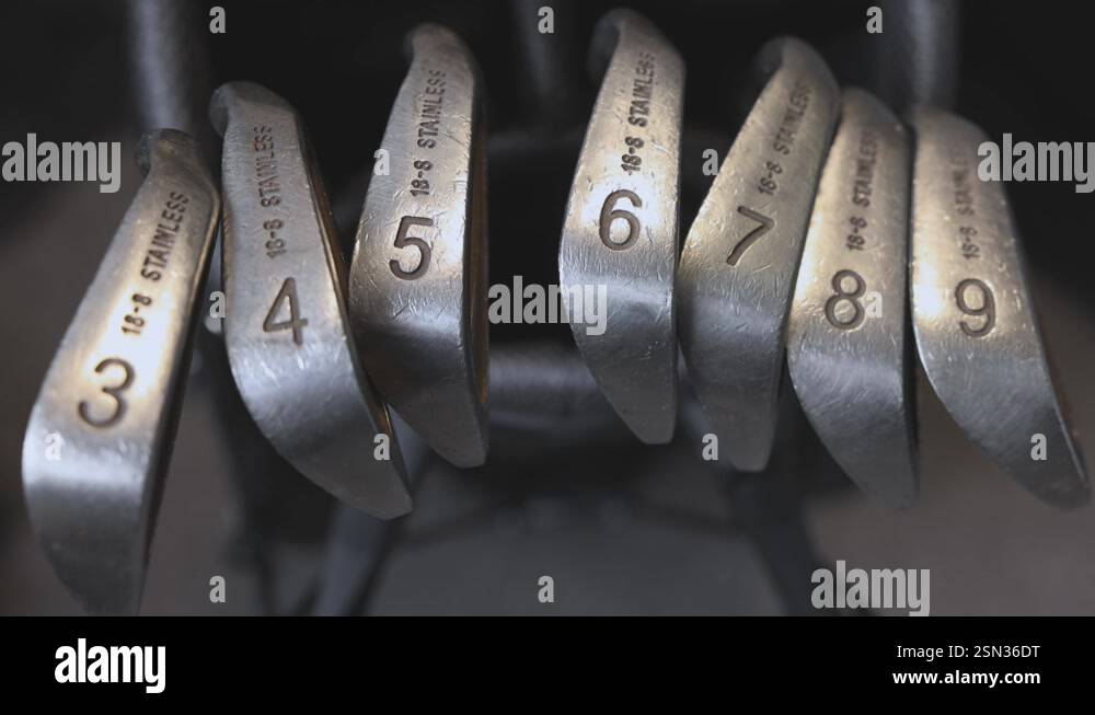 static shot of a full set of golf irons organised within a golf bag ...