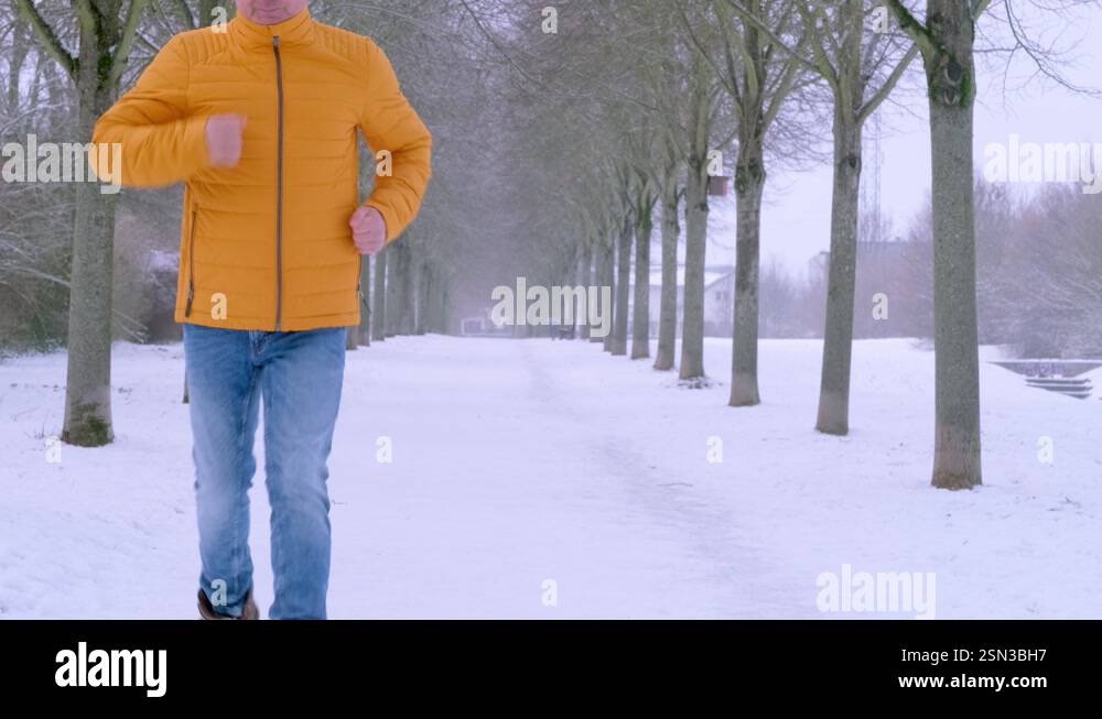 charismatic older man in orange jacket, joyful senior 65 years old runs ...