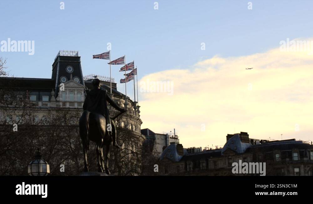 Central London buildings with British flags and plane flying Stock ...