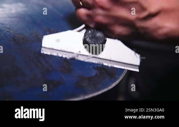 Snowboard sliding surface repair process. Close-up with shallow depth ...