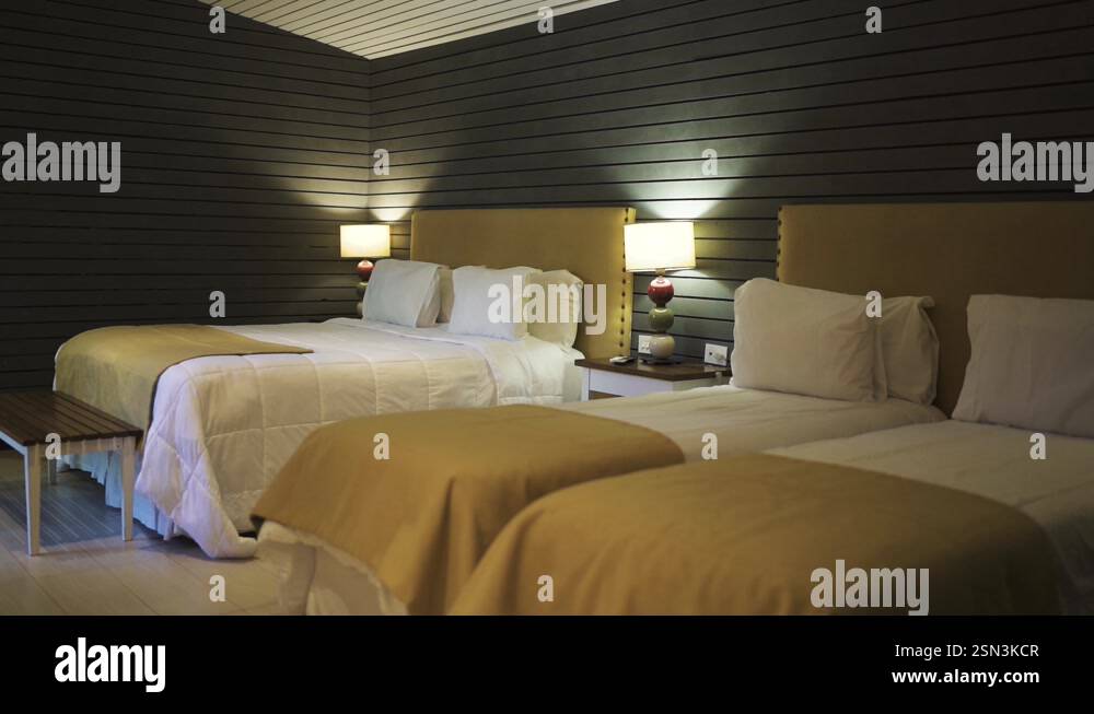 A slow panning shot reveals a luxury hotel family room featuring a ...