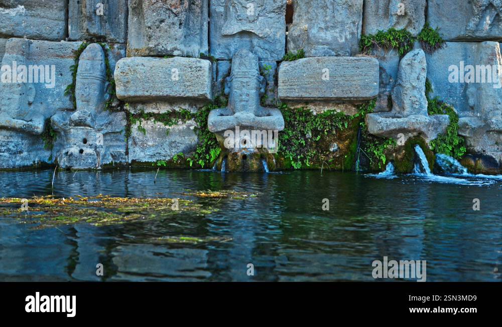 The ancient stone carvings of the Holy Water Temple, where water flows ...