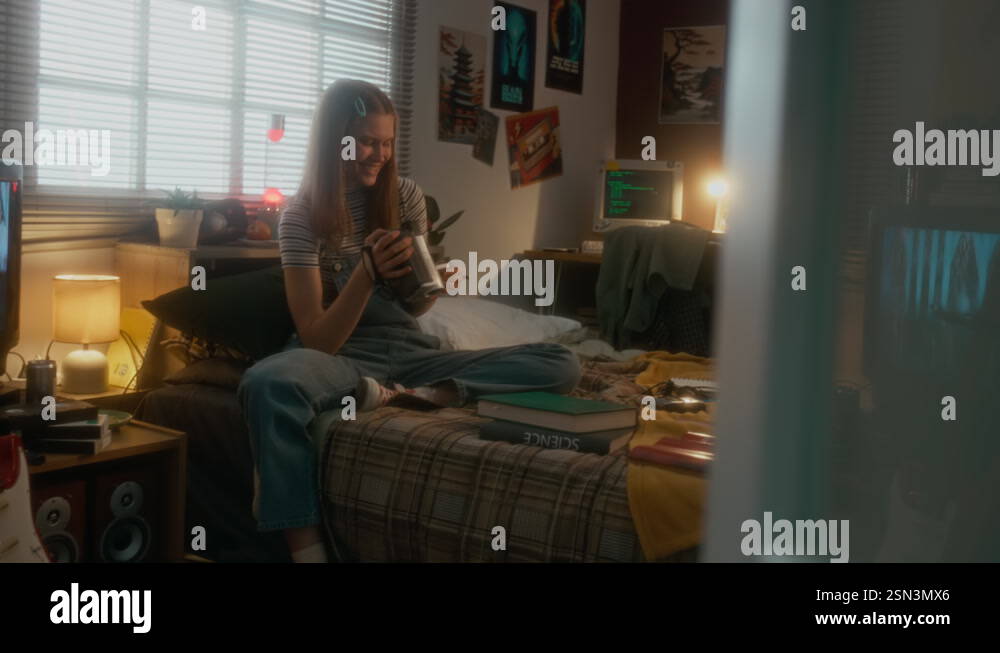 Cheerful Millennial Teenager Watching Videos on VHS Camera in Bedroom ...