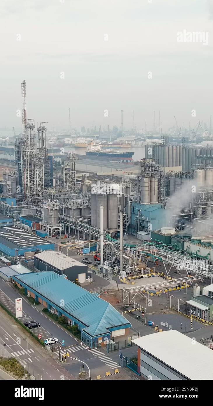 Vertical video. Antwerp, Belgium. Port infrastructure with docks and ...