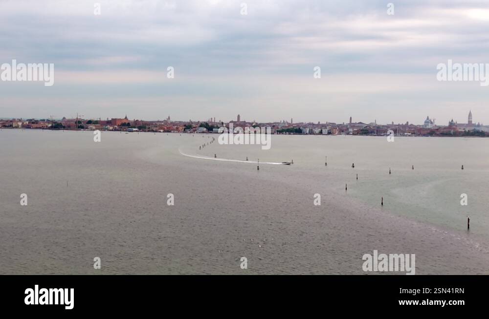 Aerial Flyover Of A Boat Cruising On A Bay With The Venice Skyline On ...