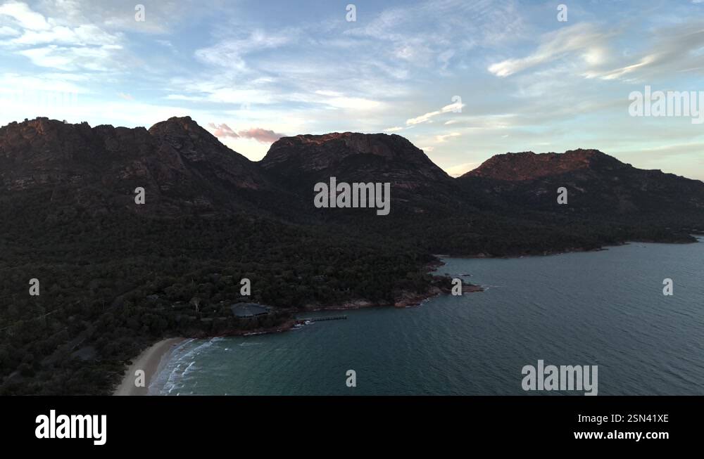 Aerial view over the mountains of Coles Bay at sunset Stock Video ...