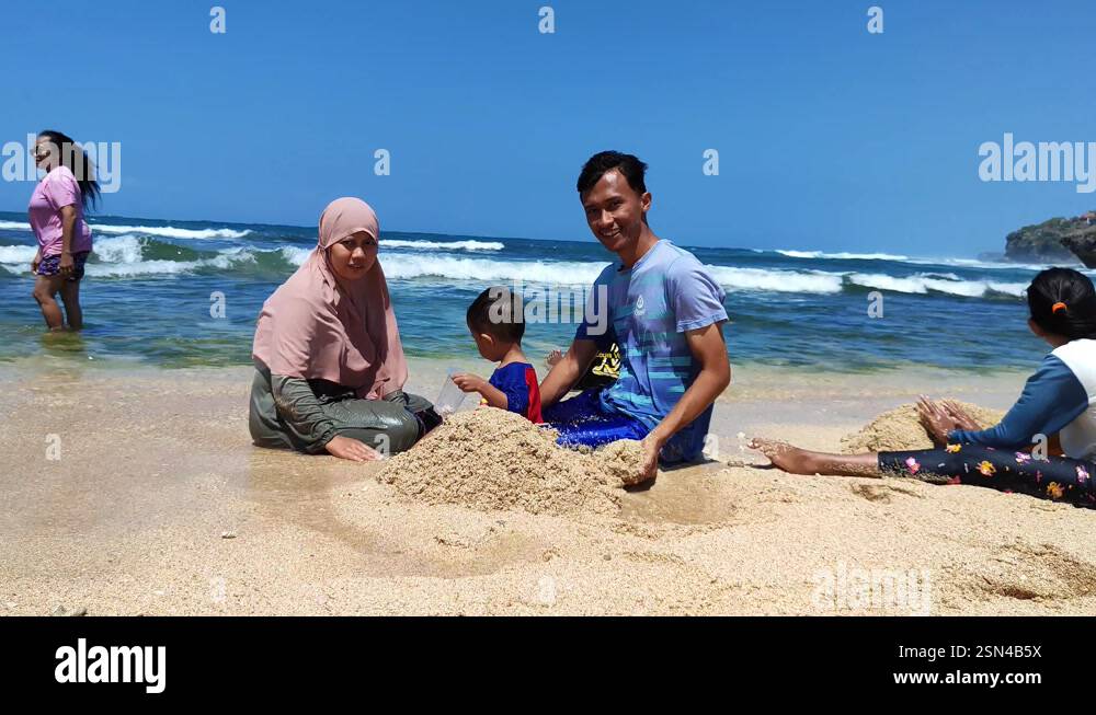 Time lapse of a happy Muslim family playing on the beach Stock Video ...