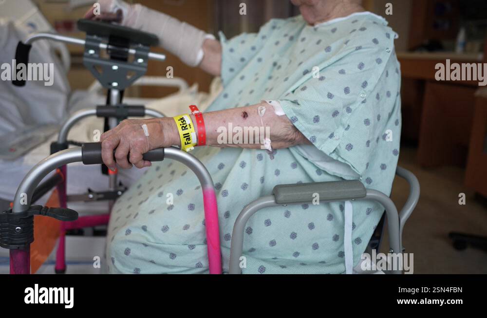 Fall Risk wristband as camera pulls back to reveal an elderly woman ...