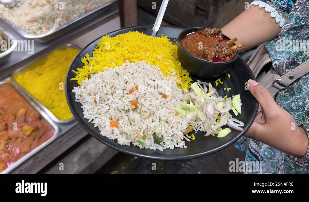 A famous Bengali dish called Basanti pulao with mutton kosha in a road ...