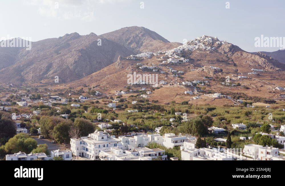 Greek island landscape aerial ascending shot. Looking at the village of ...