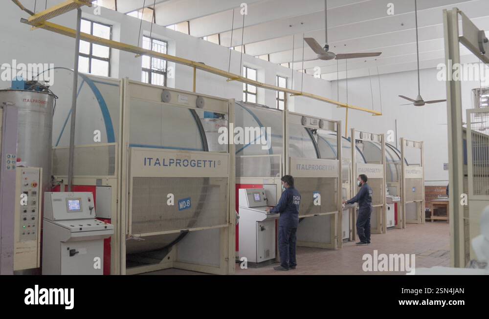 Lahore, Pakistan - 07/15/2024: Male Workers Operating A Liming And ...