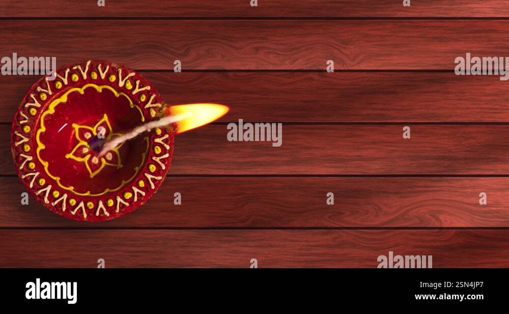 Single oil lamp and flame burns slowly on top of wooden table backdrop ...
