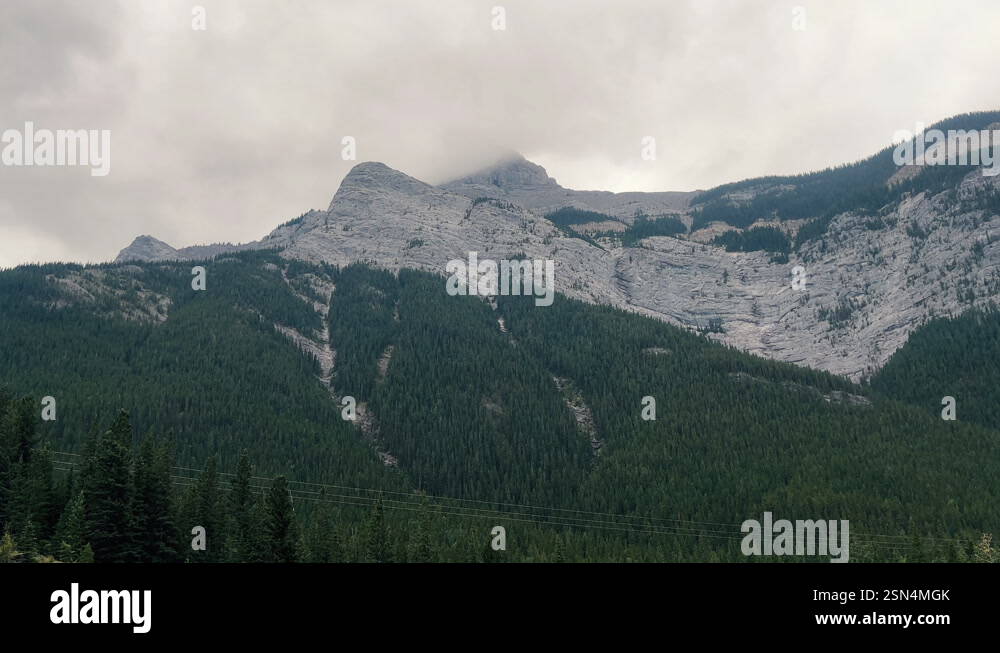 Cloud-capped Peak Of Mount Rundle In Canada's Banff National Park In ...