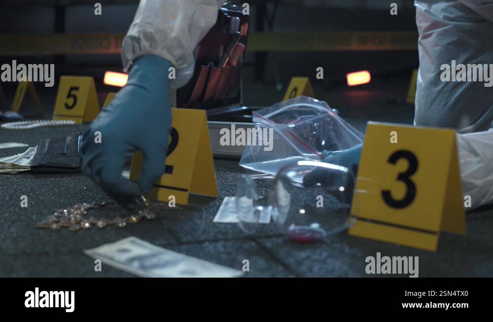 Forensic expert working at crime scene of failed robbery of wealthy ...