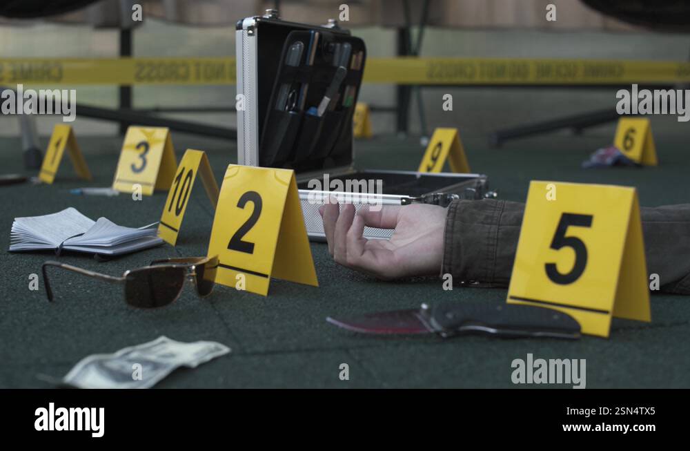 Crime scene of drug dealer murder. Lots of evidence tags, hand of ...