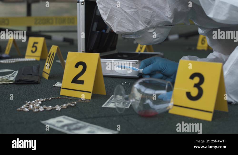 Forensic expert working at crime scene of failed robbery of wealthy ...
