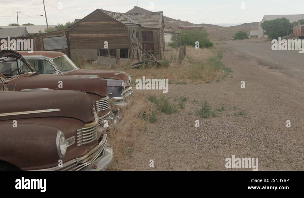Rusty cars from the fifties in backyard of former garage. Close up ...