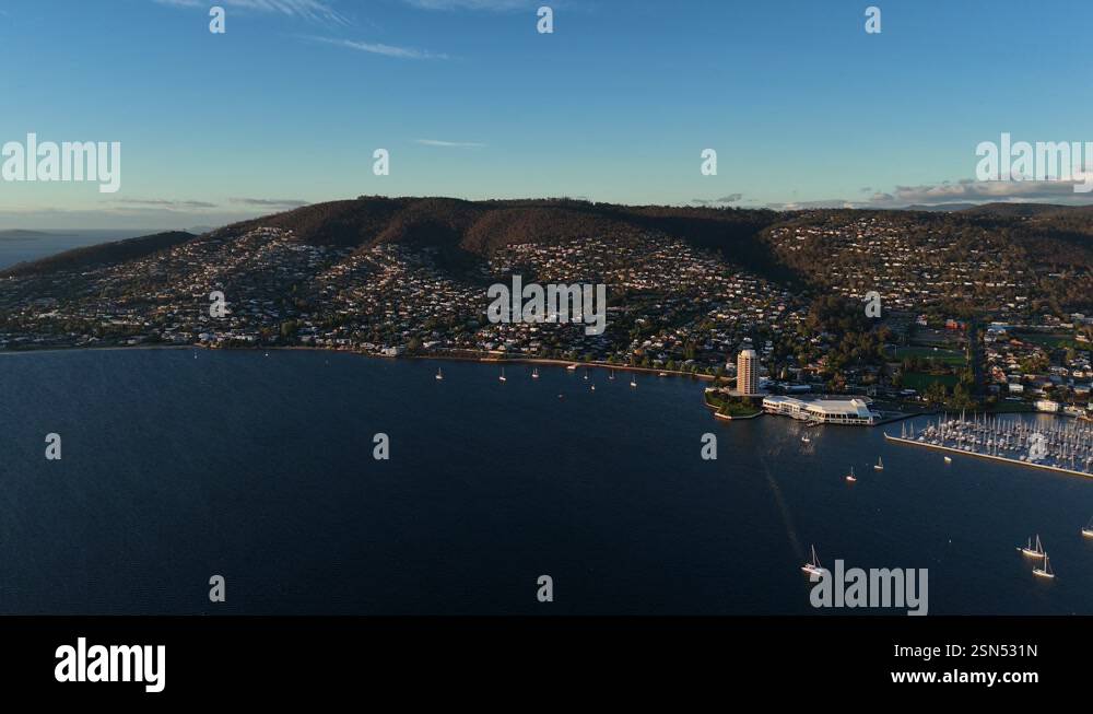 Beautiful coastline of Tasmania with city of Hobart during golden ...
