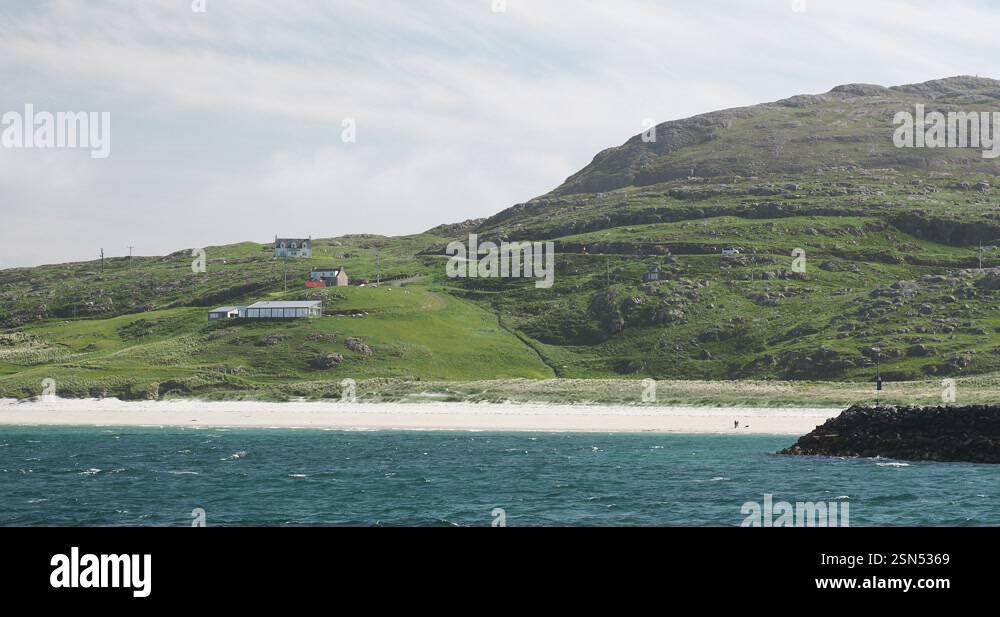 A modern house and traditional houses on Eriskay in the Outer Hebrides ...