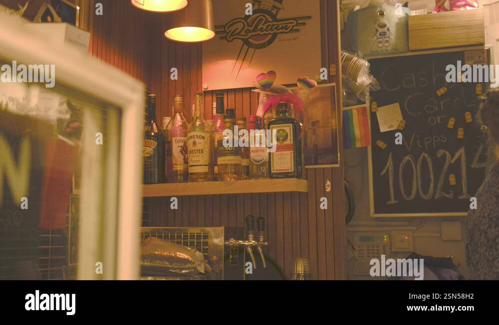 Alcohol bottles inside dingy Raketten Bar in Tromso, Norway f-log Stock ...