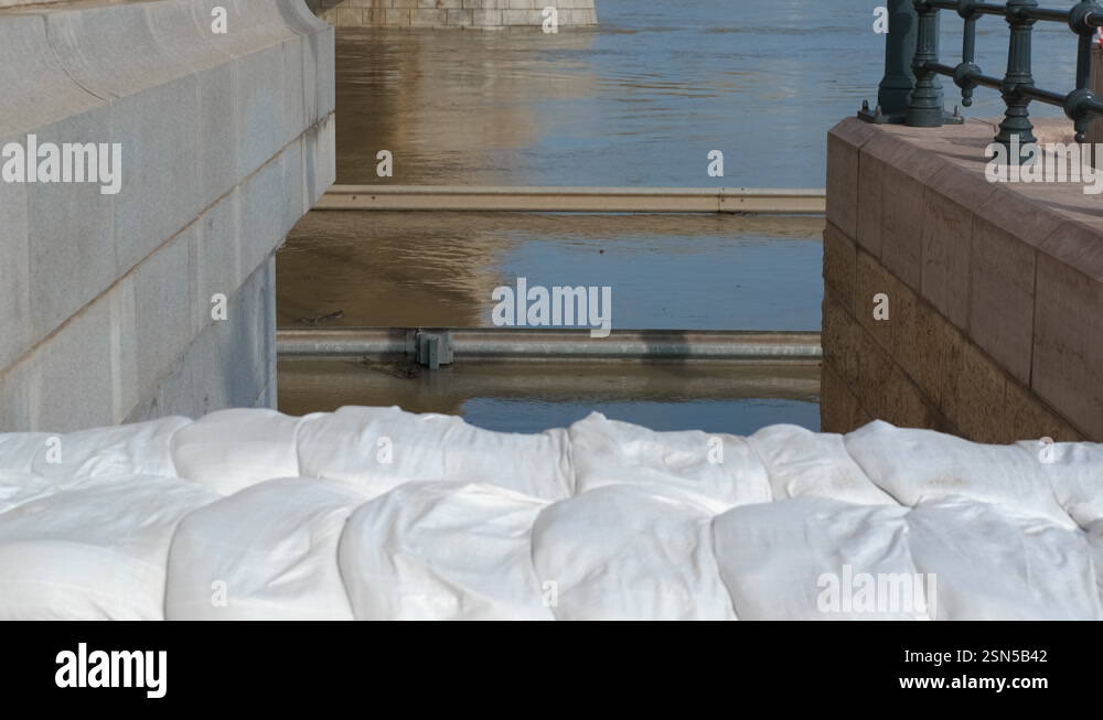 River water level decreasing showing sandbags protecting city Stock ...