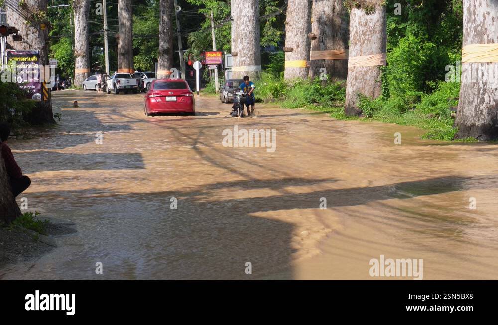 Residents wade through flooded streets as rivers overflow during rush ...