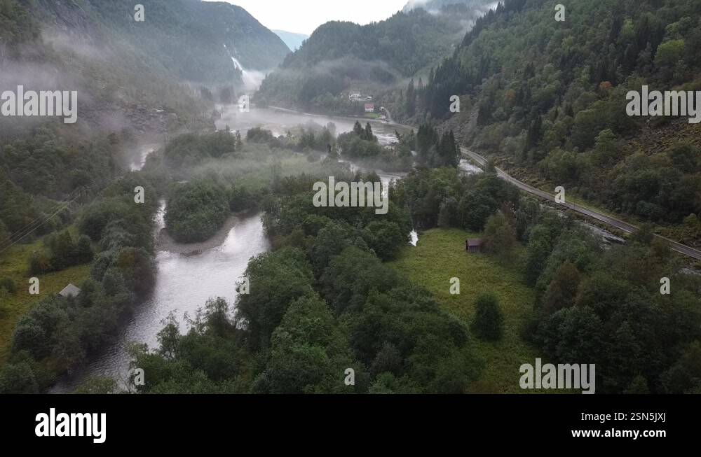 The shot shows a large steep valley and a very wide valley flowing ...