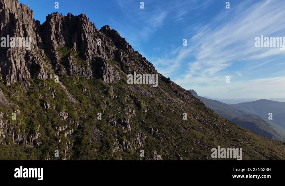 Aerial flight along mountain range of Cradle Mountain Area in Tasmania ...