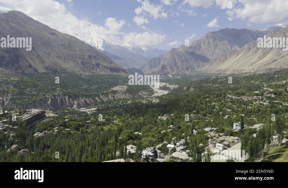 Hunza Valley landscape, tilt up, with a mix of trees, houses, and ...