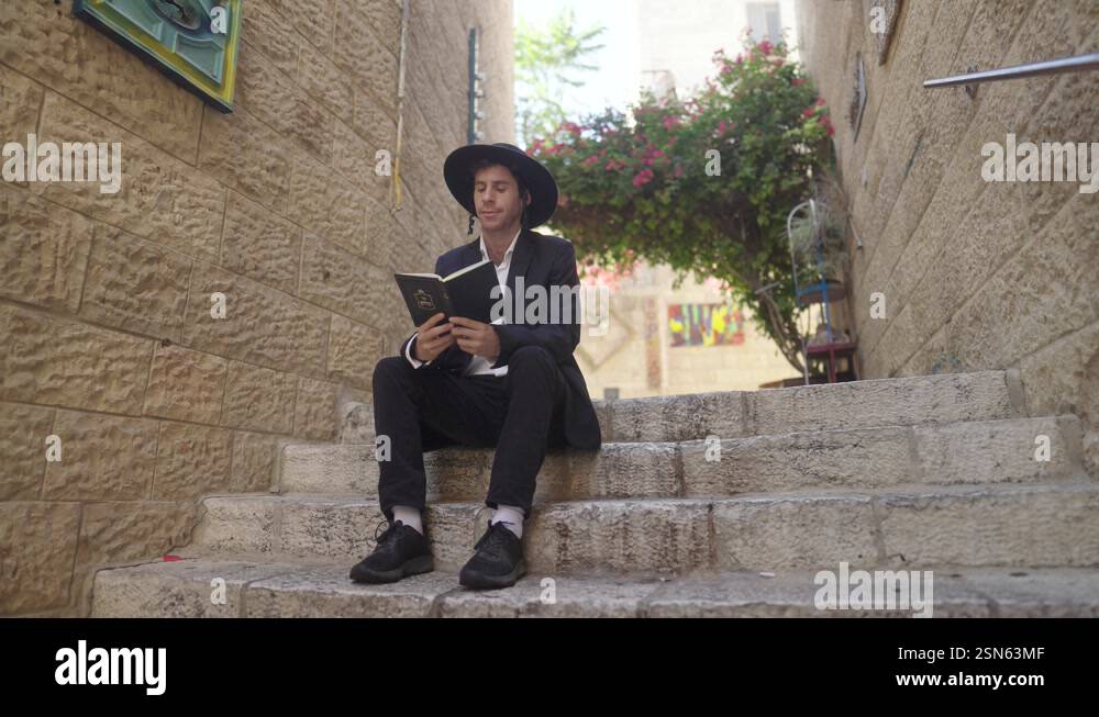 Orthodox Jewish Man Reading Sacred Book While Sitting On Stairs In ...
