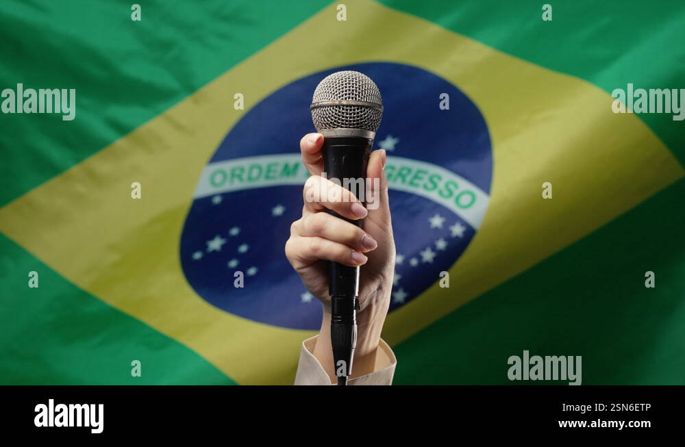 Woman singer or TV presenter holding mic, mike or microphone in hand on ...