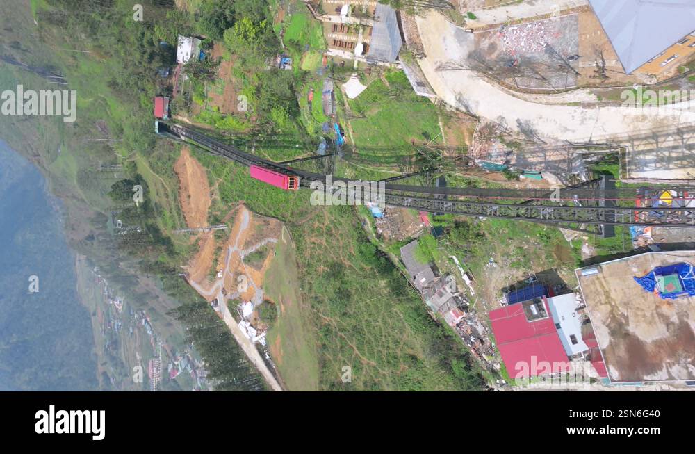 Vertical - Drone Following Red Funicular Train On Rail Track To ...