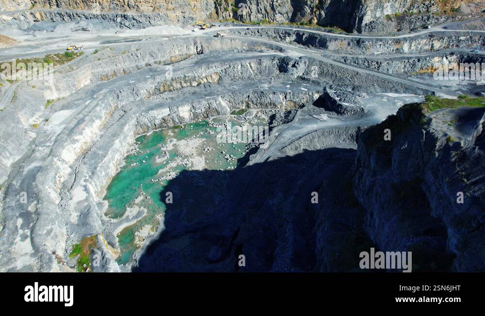 Mining drone landscape view of deep quarry mining limestone with green ...