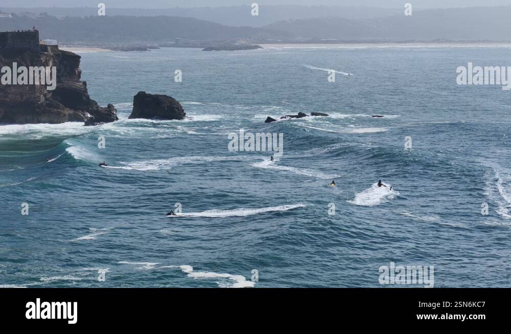 Surfers tackle massive waves in Nazare, Portugal during epic winter ...
