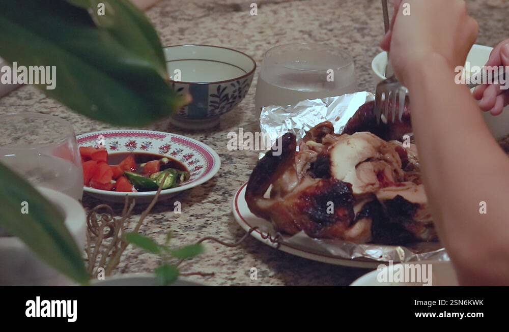Eating lechon manok or Filipino roasted chicken and rice with soysauce ...