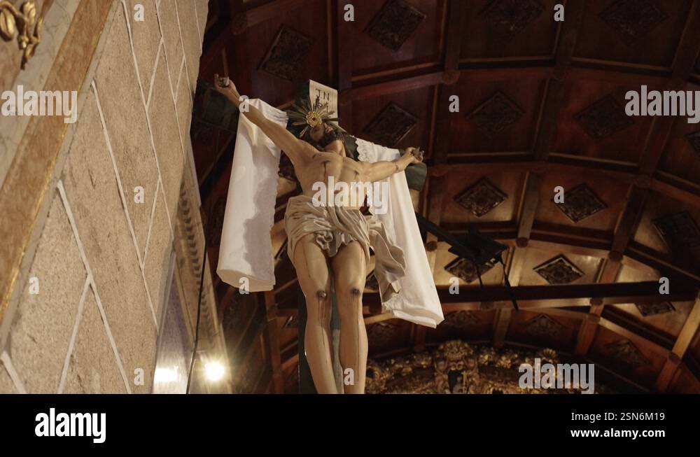 Crucifix of Jesus Christ mounted on a stone wall inside a church, under Stock Video Footage - Alamy