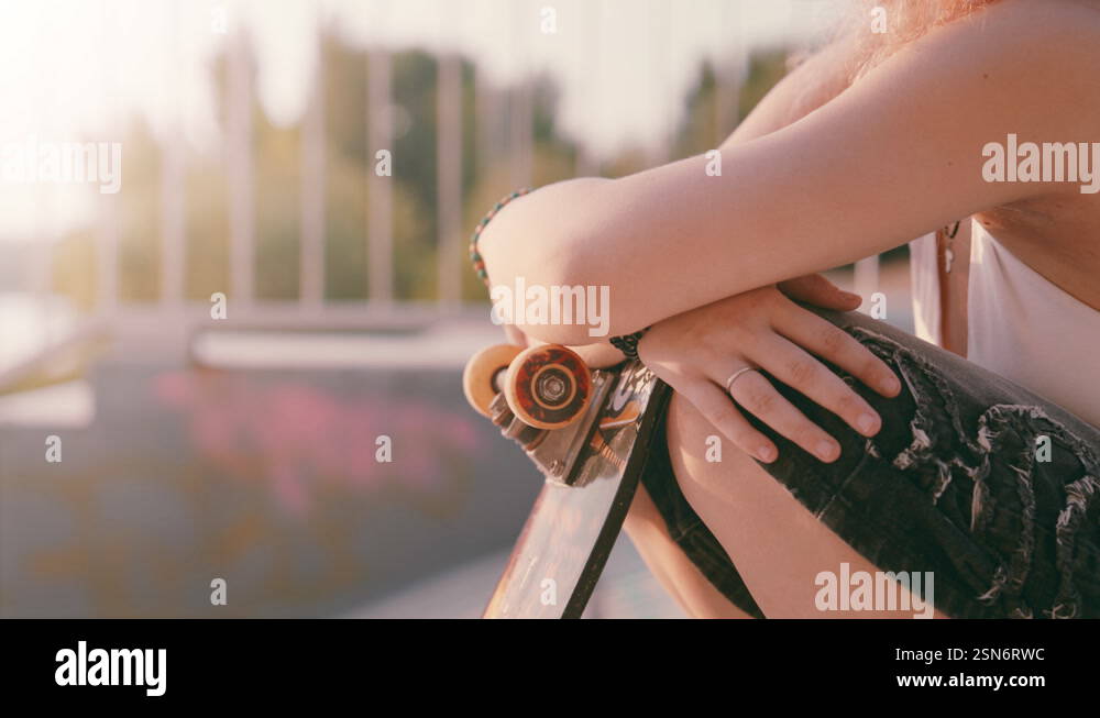 Denim-Clad Teen Embraces Skateboard: Closeup of Bent Knees on Concrete ...