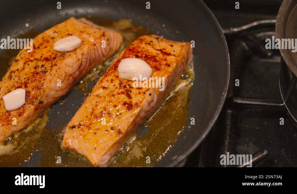 Overhead View of Two Salmon Fillets Cooking in Frying Pan with Butter ...