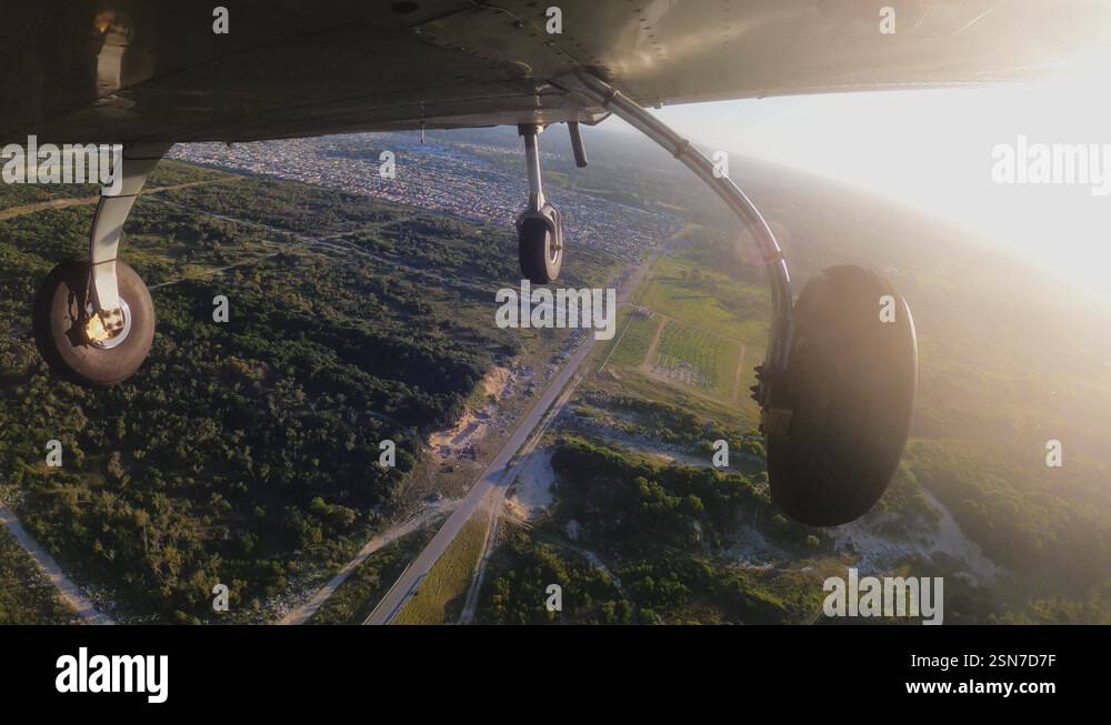 Light three wheels training airplane doing ledt turn from base for the ...