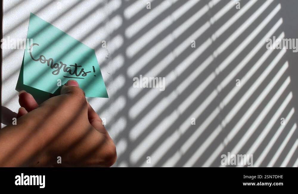 Female Hand Pulling Sticky Notes With Words Congrats From The Wall With ...