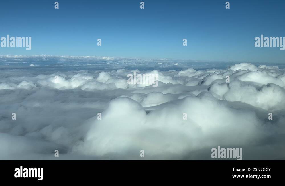 Pilot’s FPV POV flying over a sea on fluffy sinuous white stratus ...